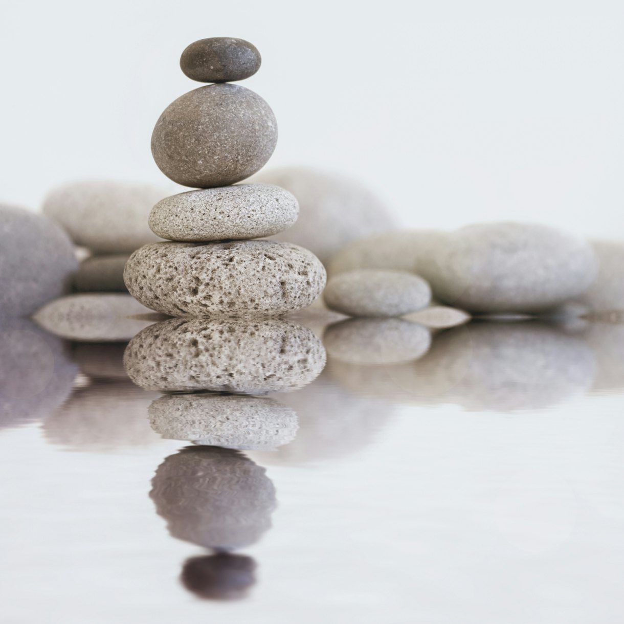 Stone Cairn Reflecting in Calm Water Wallpaper - Happywall